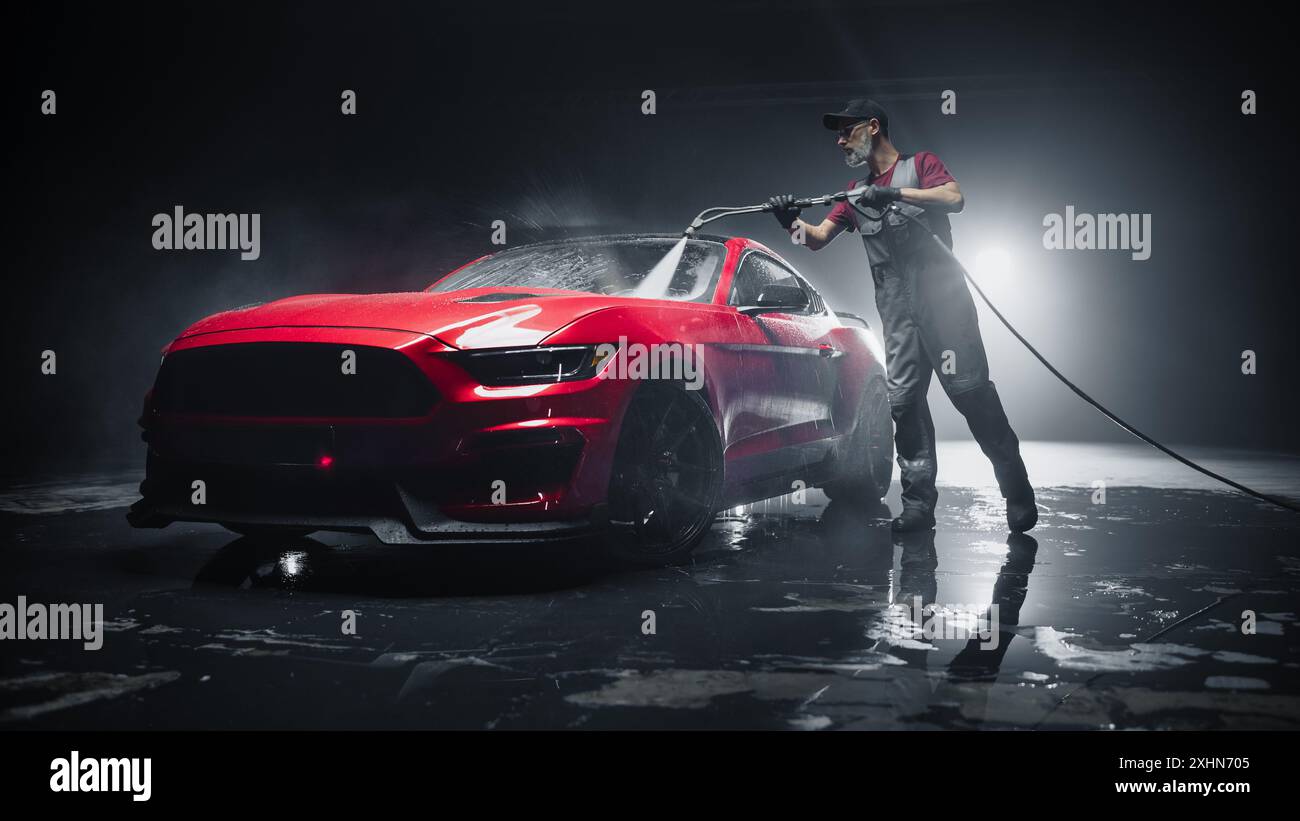Car Wash Expert Using Water Pressure Washer to Clean a Red Modern ...