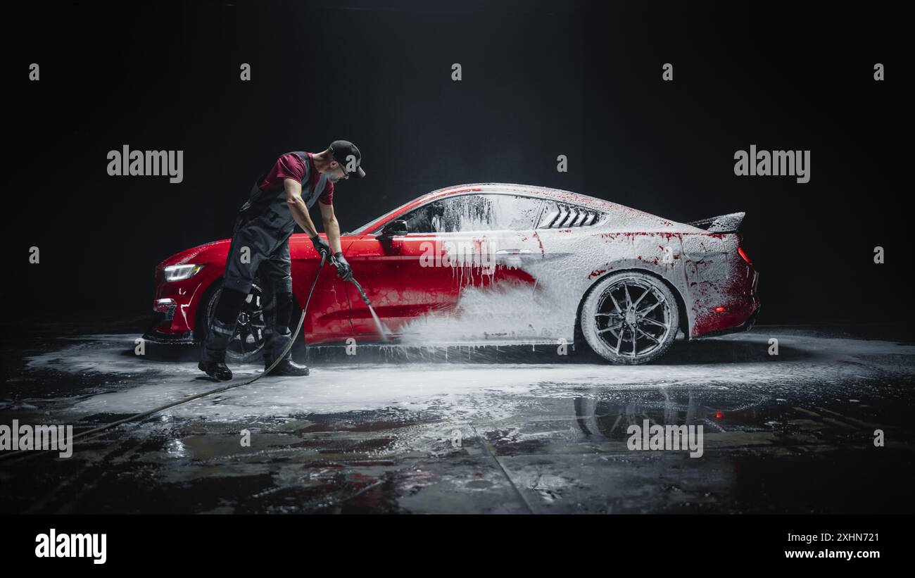 Car Wash Specialist Using Pressure Washer to Rinse a Red Modern ...