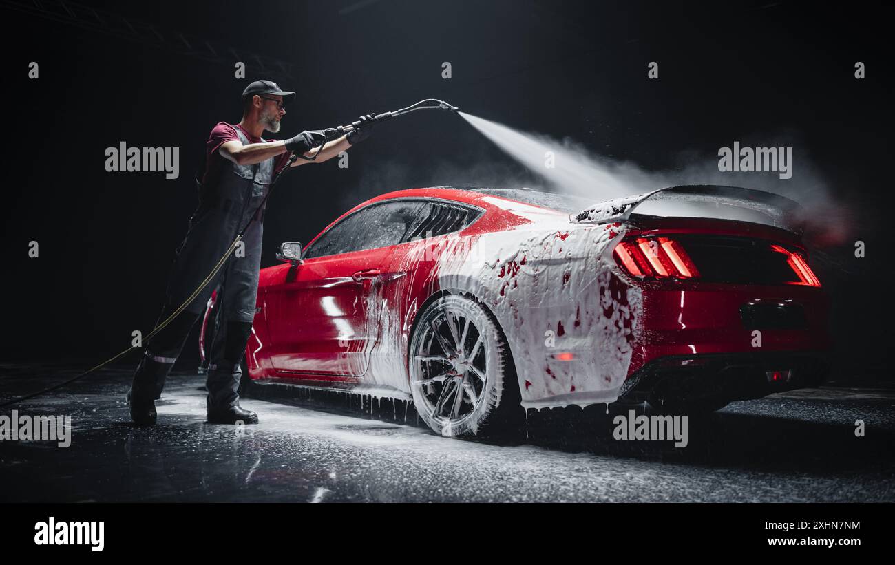 Automotive Detailer Washing Away Smart Soap and Foam with a Water High ...