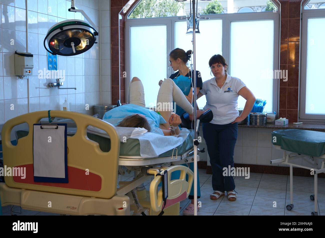 At the delivery room. Woman giving birth lying in the chair, doctors ...