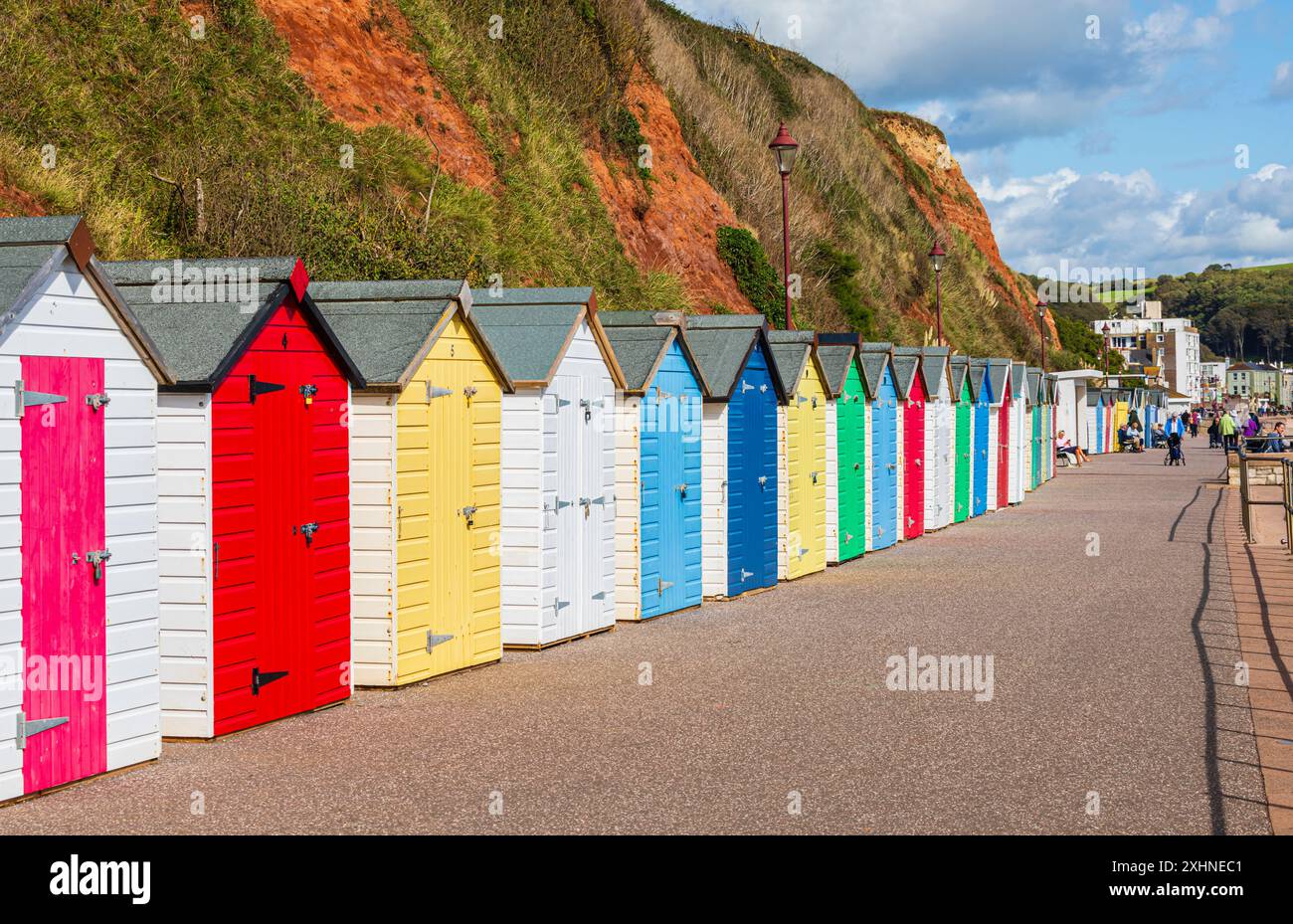 Colourful beach huts under the cliffs along the seafront promenade at ...