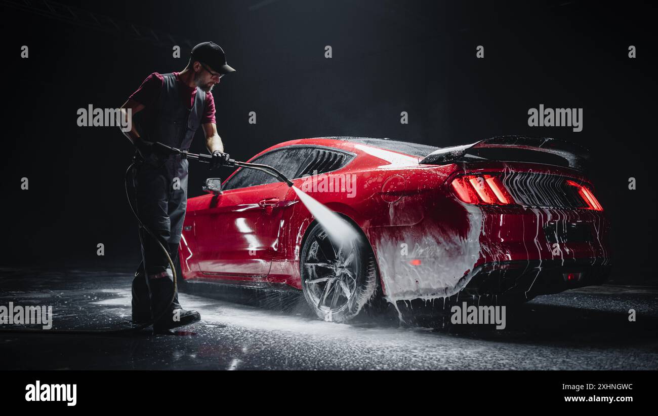 Automotive Detailer Washing Away Smart Soap and Foam with a Water High ...