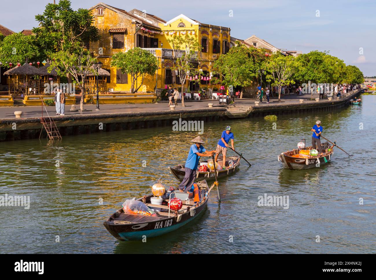 traditional Vietnamese fishing boats going along Thu Bon River at Hoi ...