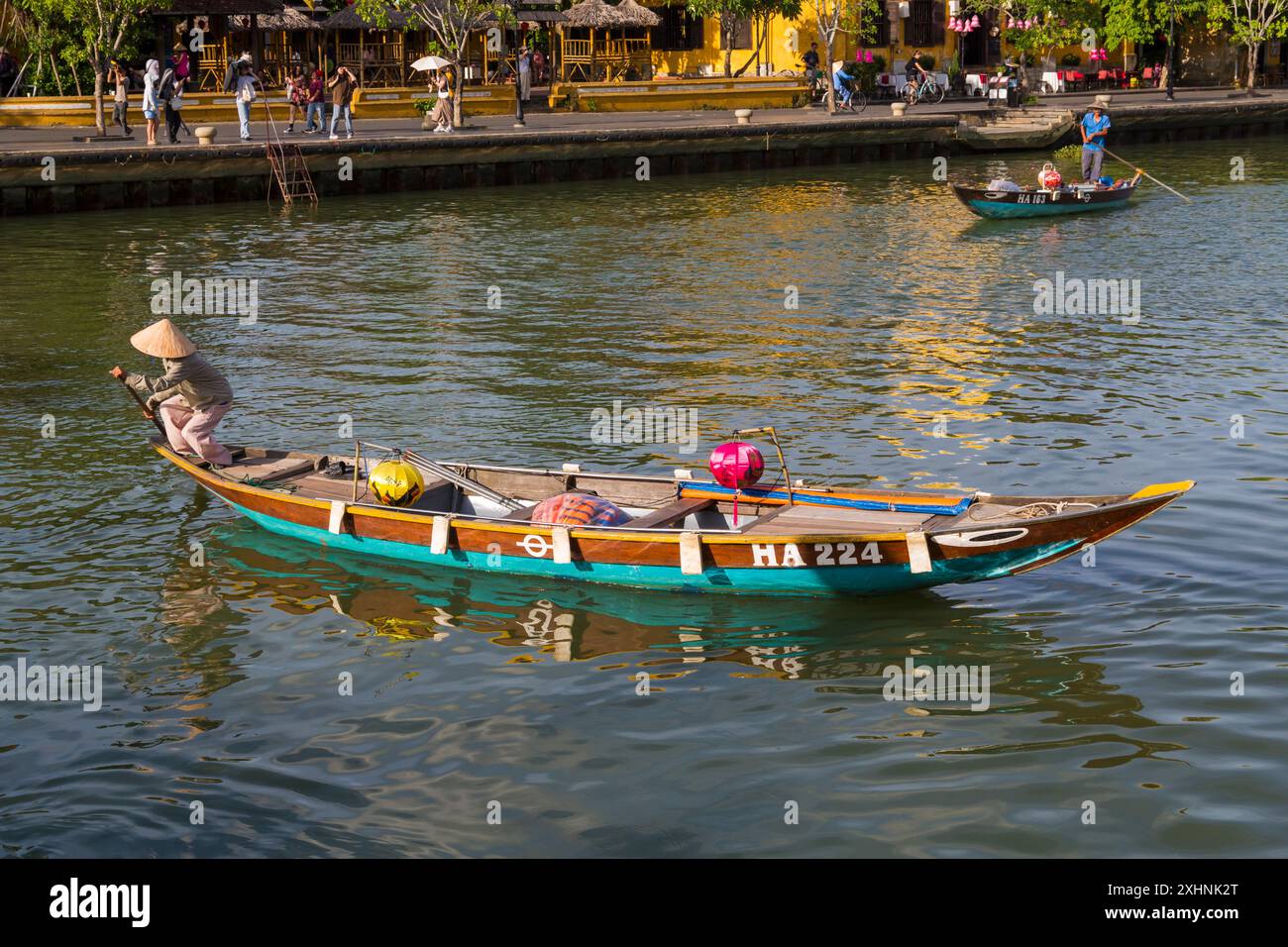 traditional Vietnamese fishing boat going along Thu Bon River at Hoi An ...