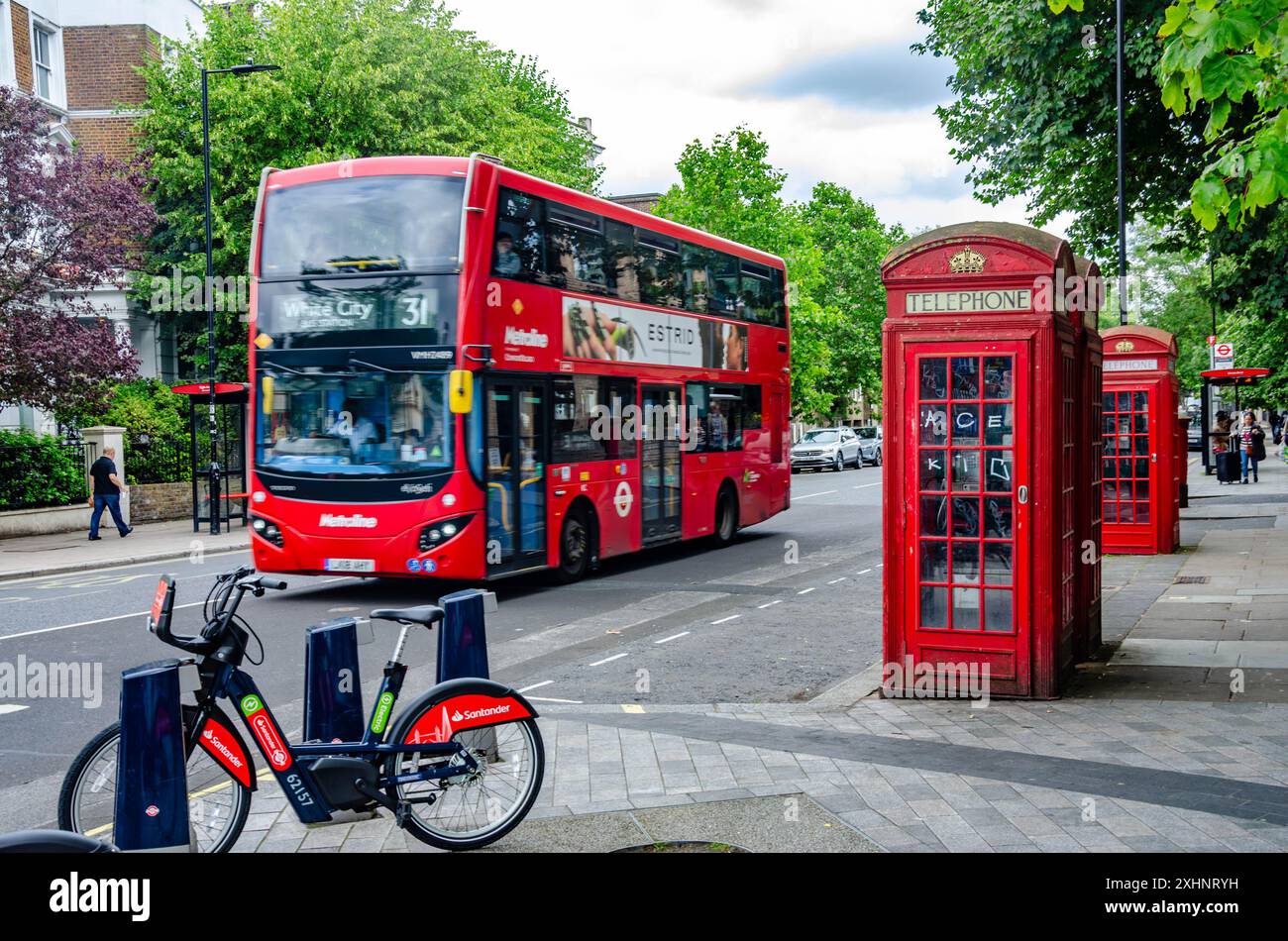 The no 31 double decker bus to White City passes a couple of old red ...
