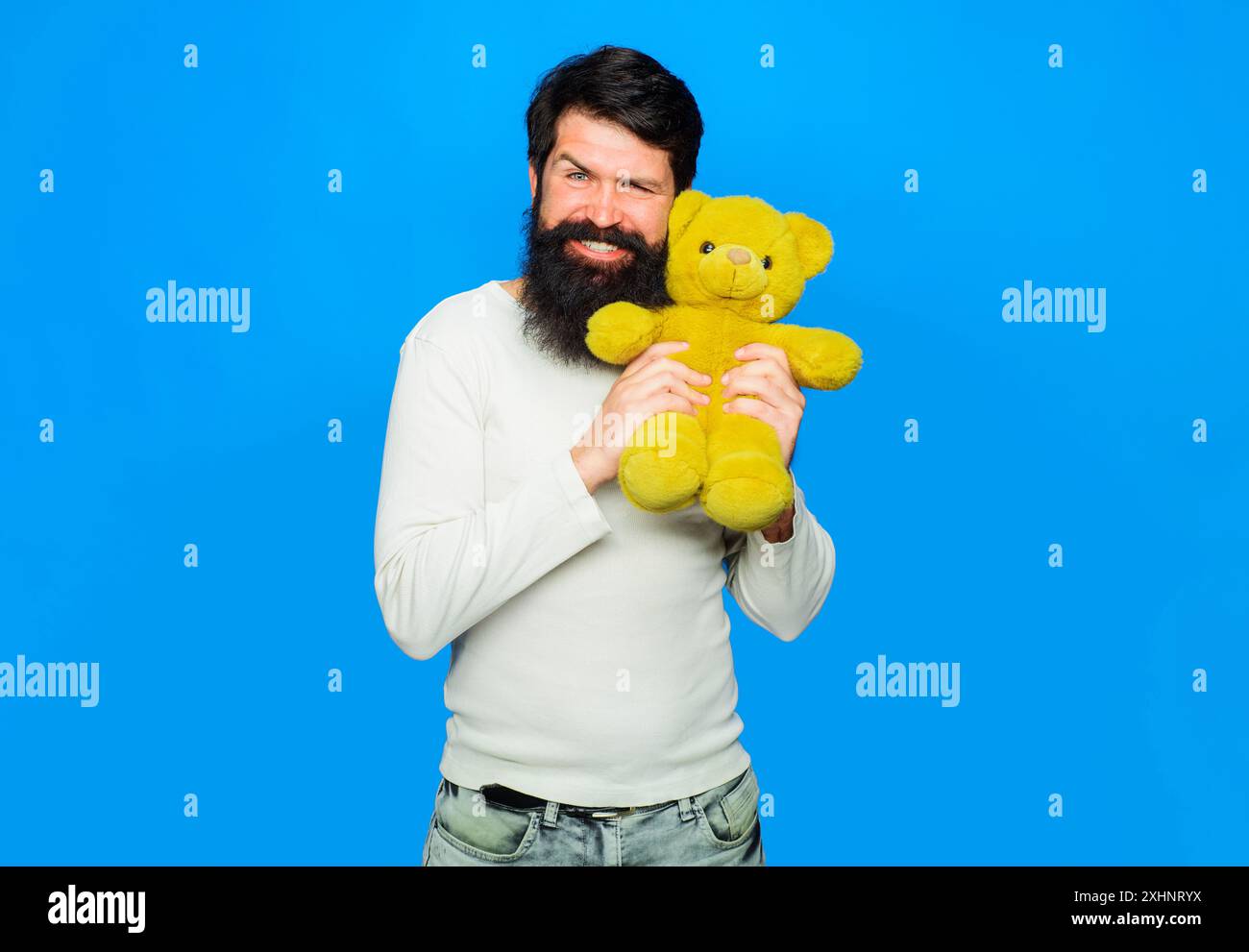 Bearded man with teddy bear. Handsome male hugs plush teddy bear. Gift ...