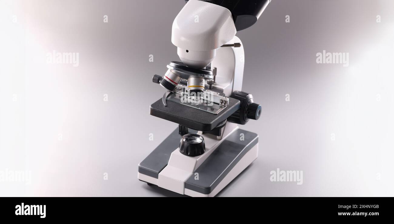 Modern microscope tool for laboratory research on grey background Stock ...