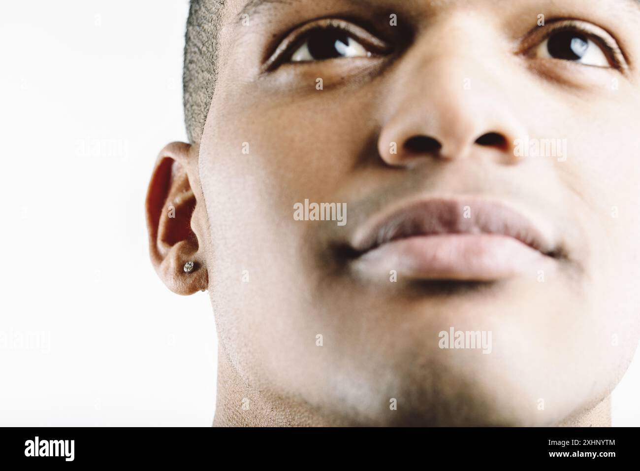ear-ring on a closeup portrait of a young black man's ear Stock Photo ...