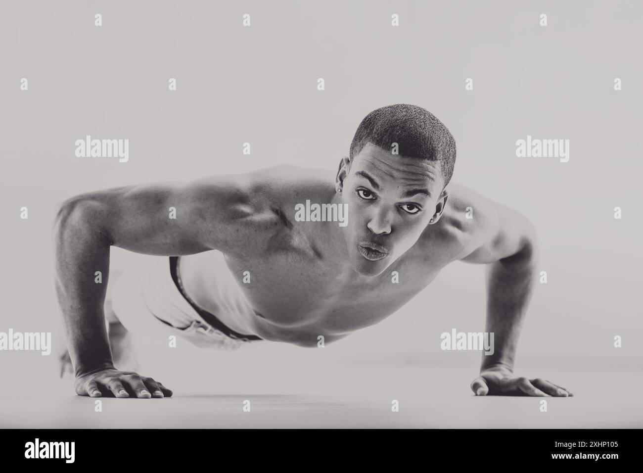 Muscular black man in vintage 1950s style doing push-ups, showcasing ...