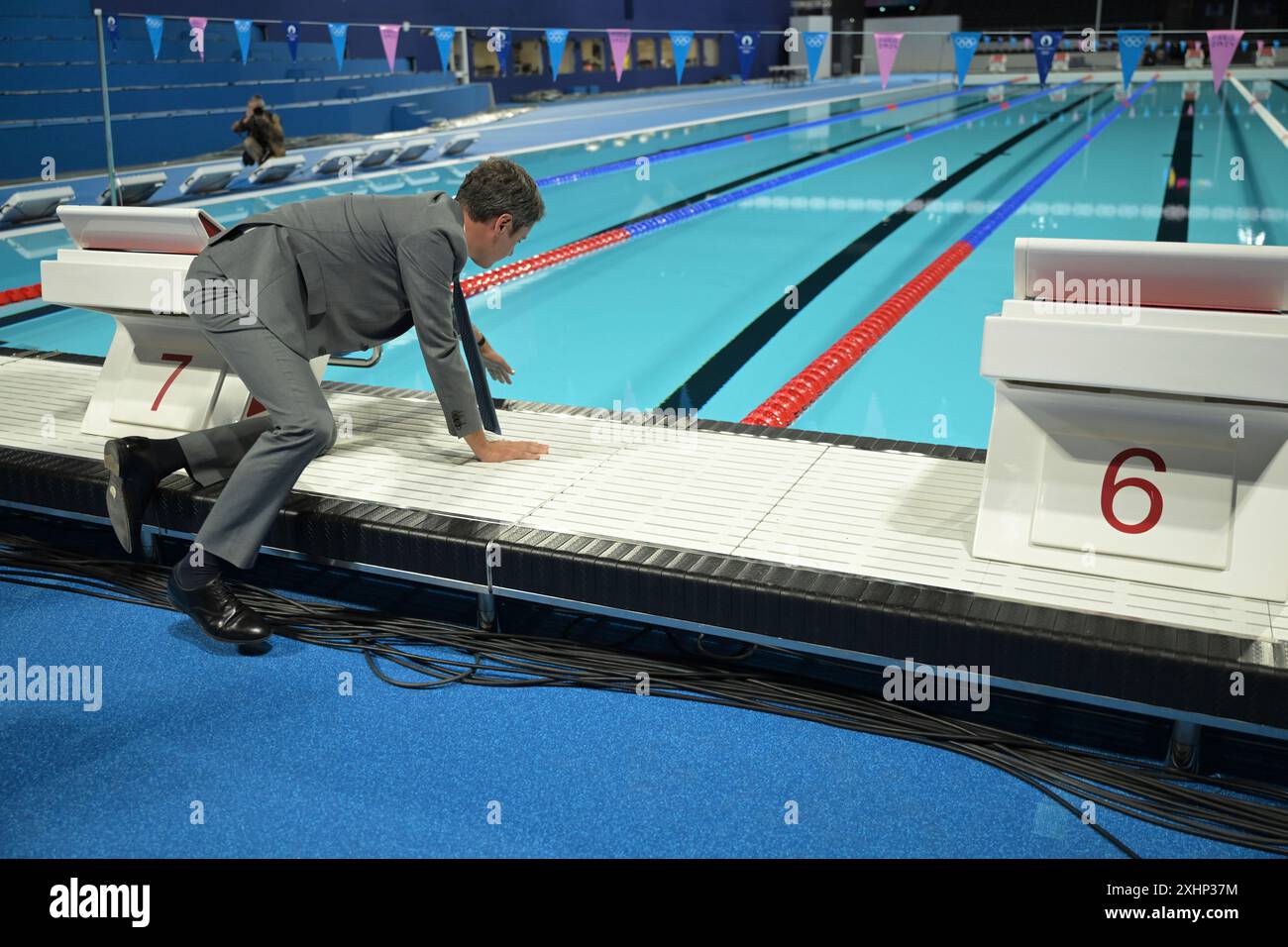 French Prime Minister Gabriel Attal touches the water at the swimming ...