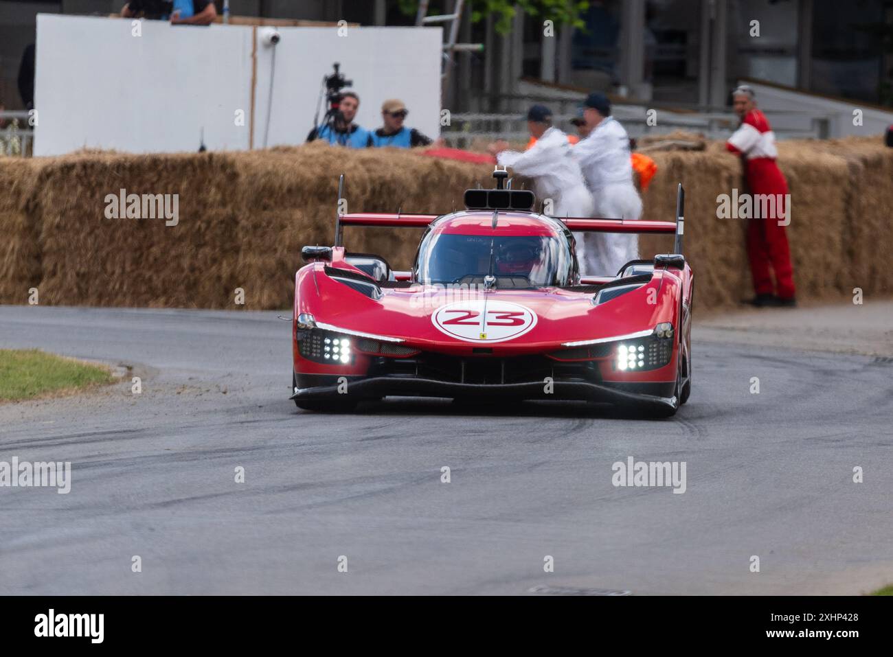 Ferrari 499P Modificata driving up the hill climb track at the Goodwood ...