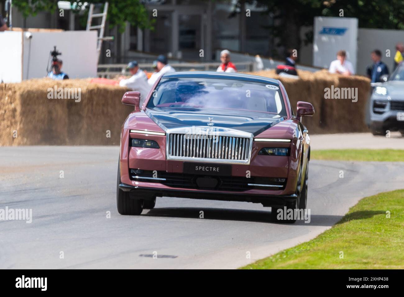 Rolls Royce Spectre luxury electric car driving up the hill climb track ...