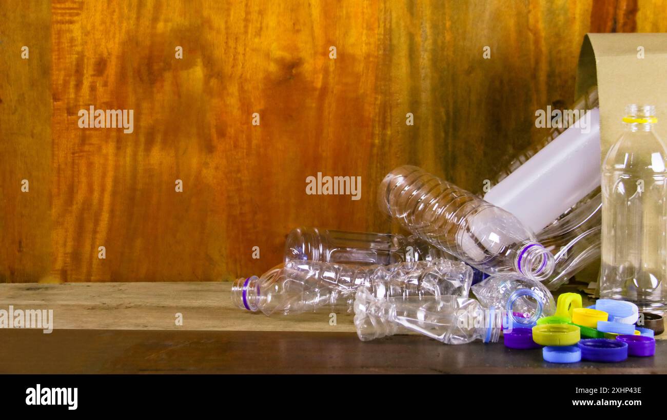 Clear plastic bottles on a wooden surface awaiting recycling. Promotes ...