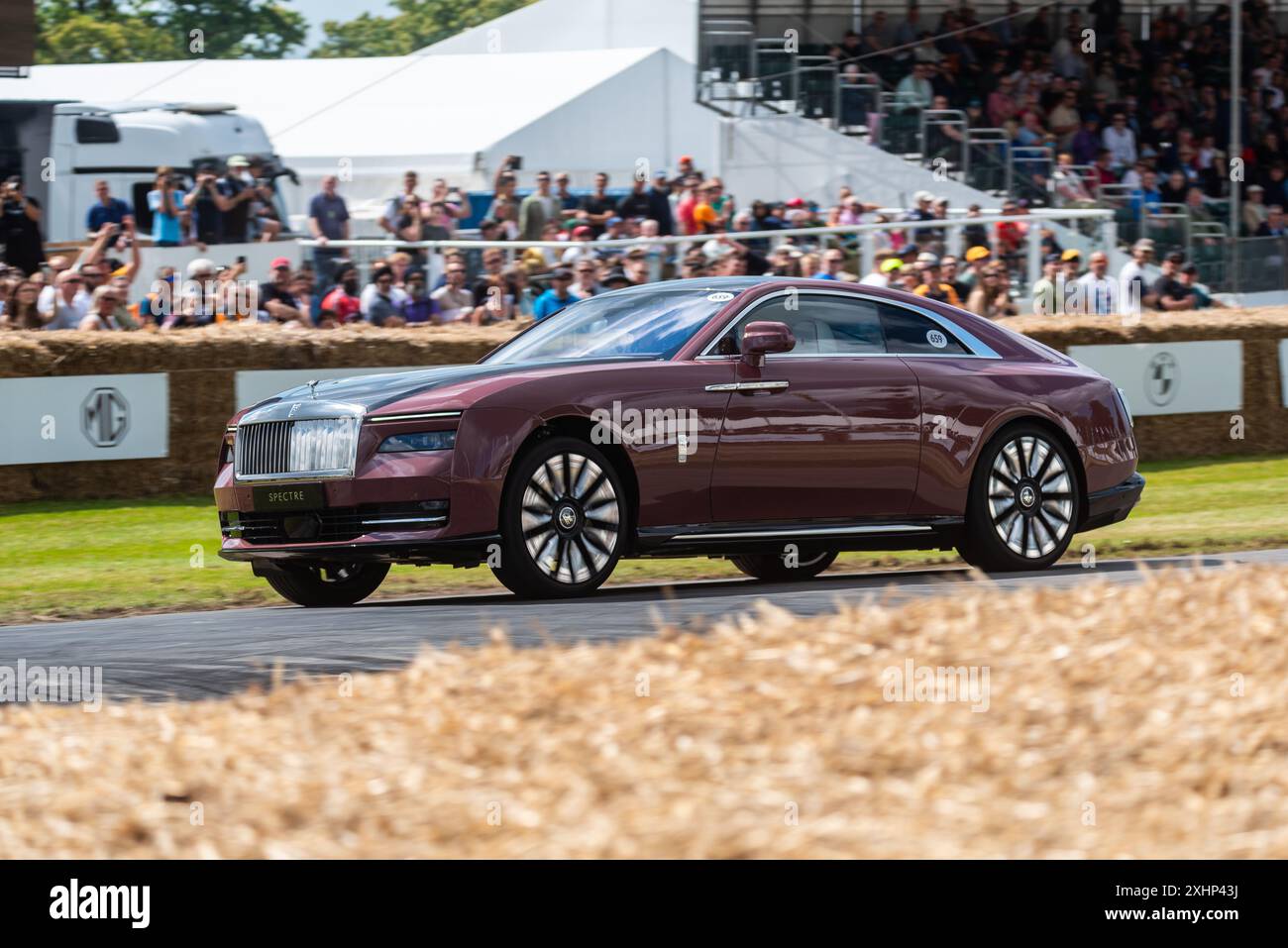 Rolls Royce Spectre luxury electric car driving up the hill climb track ...