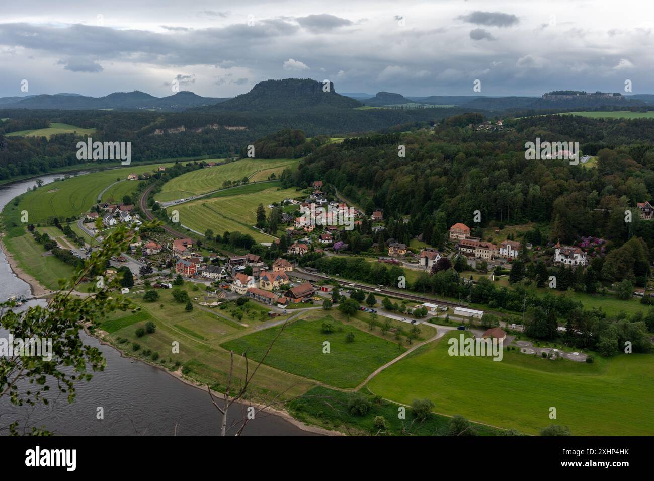 A town is shown with a river running through it. The houses are small ...