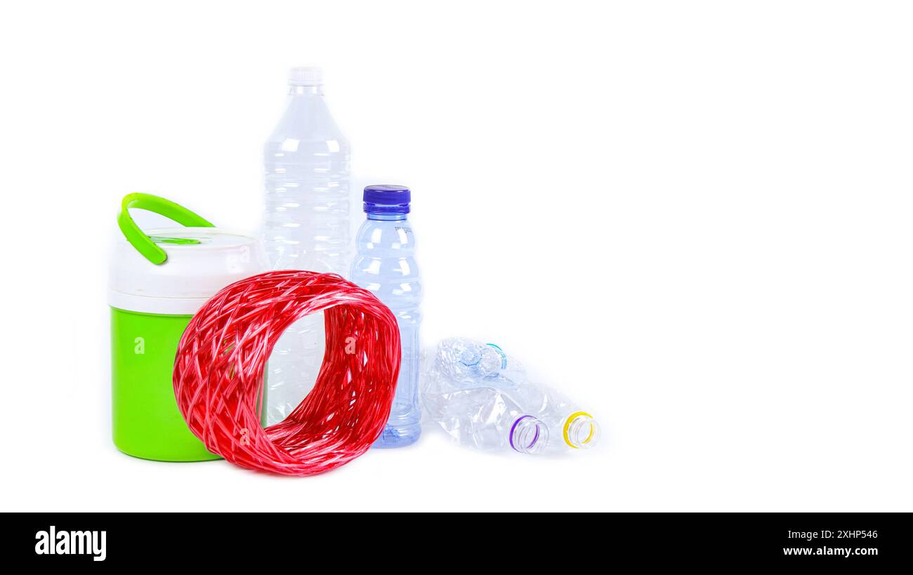 Clear plastic bottles on a white surface, awaiting recycling ...