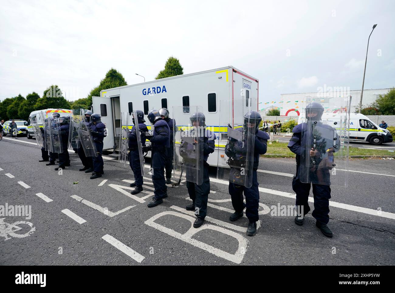 Members of gardai public order unit surround a custody van as some ...