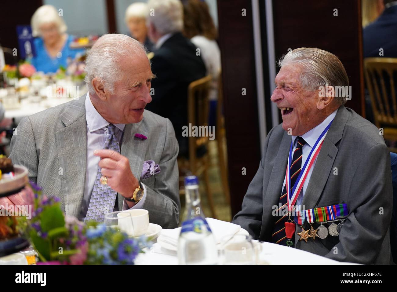 King Charles III (left) meets Normandy veteran Ernest Thorne during a ...