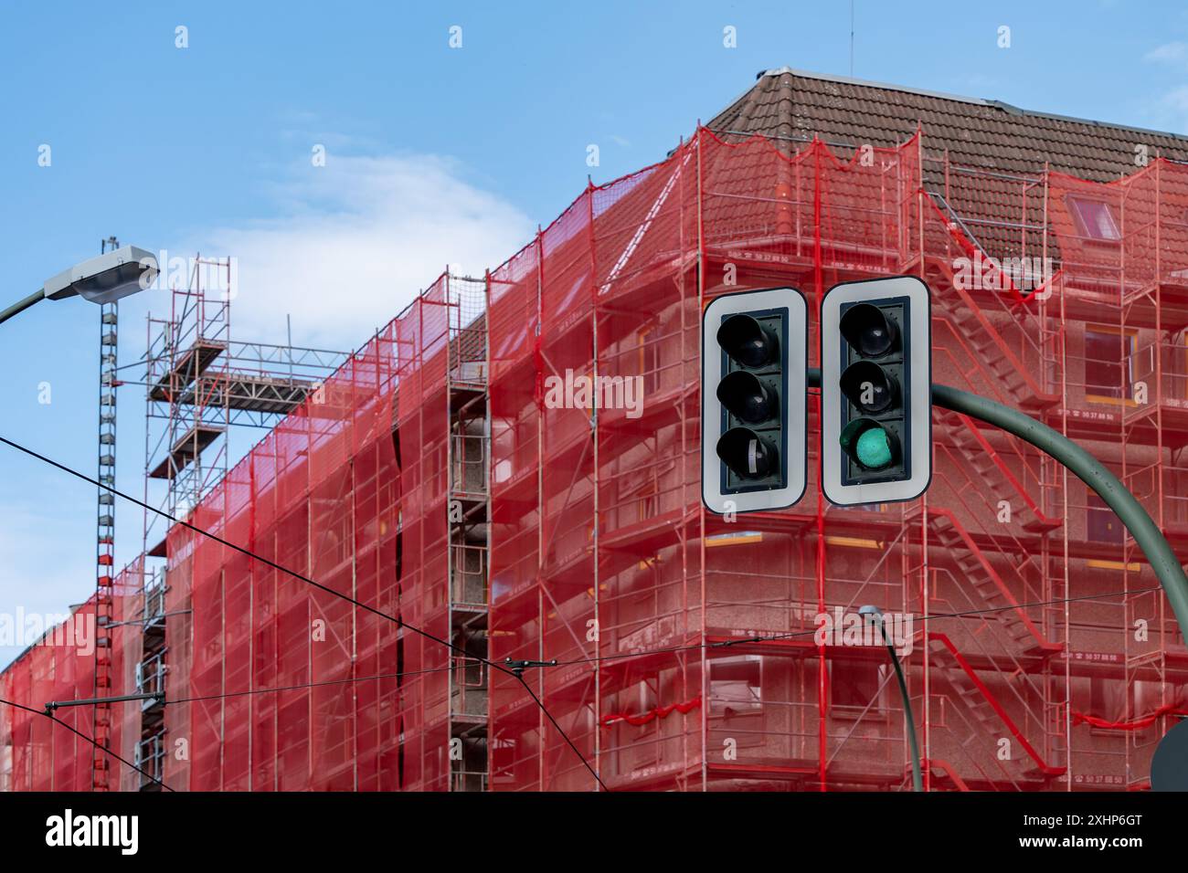 A construction site with scaffolding and a red and white construction ...
