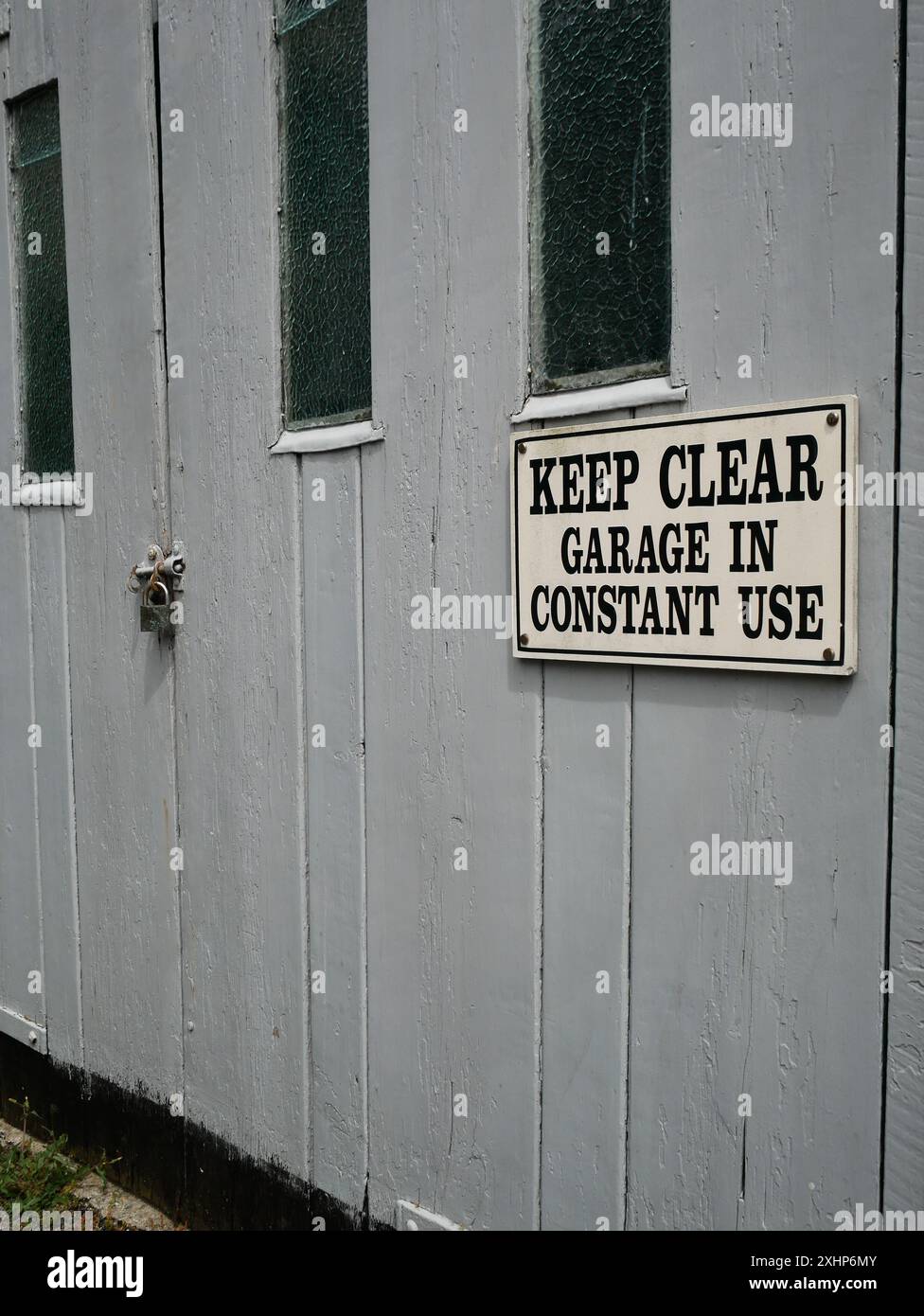 Keep clear garage in constant use sign on wooden garage doors Stock ...