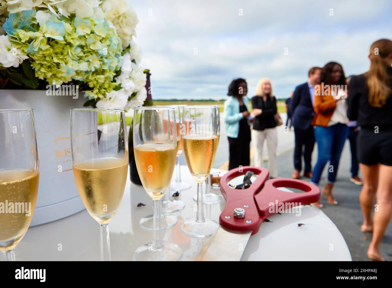 Several guests attend the ribbon cutting for a new private jet delivery ...