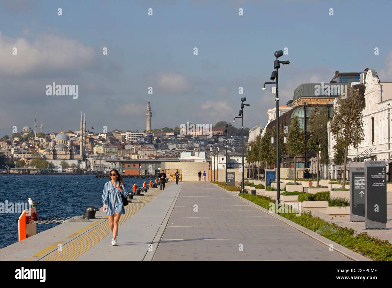 Turkey, Istanbul, Galataport, young woman in dress strolling on the ...