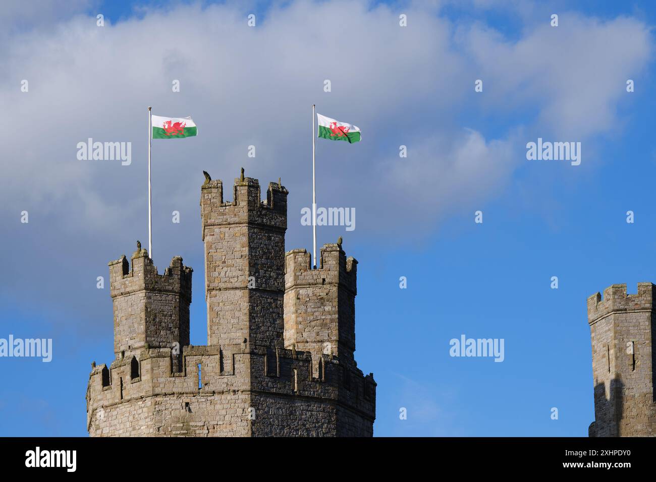 Two Welsh flags flying above Caernarfon Castle in North Wales Stock ...