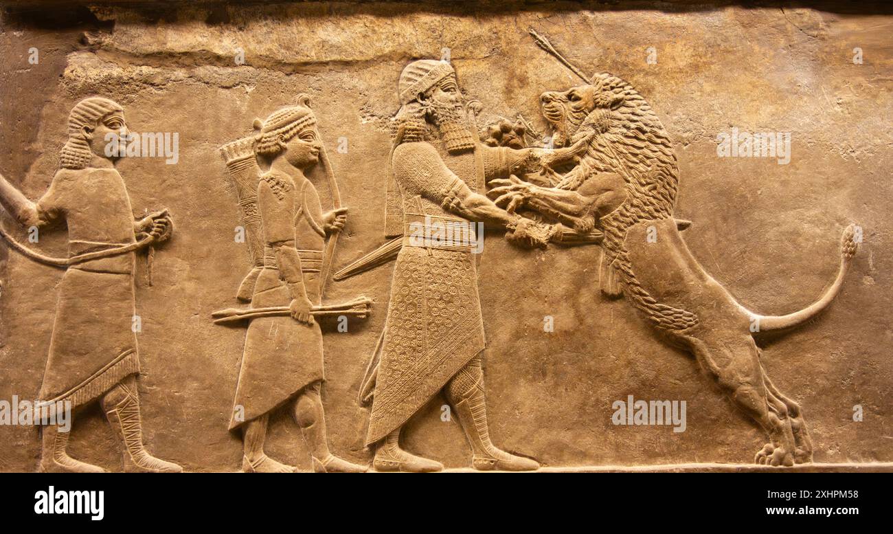 King Ashurbanipal killing a lion with a sword. Lion Hunt of Ashurbanipal. British Museum, London ...