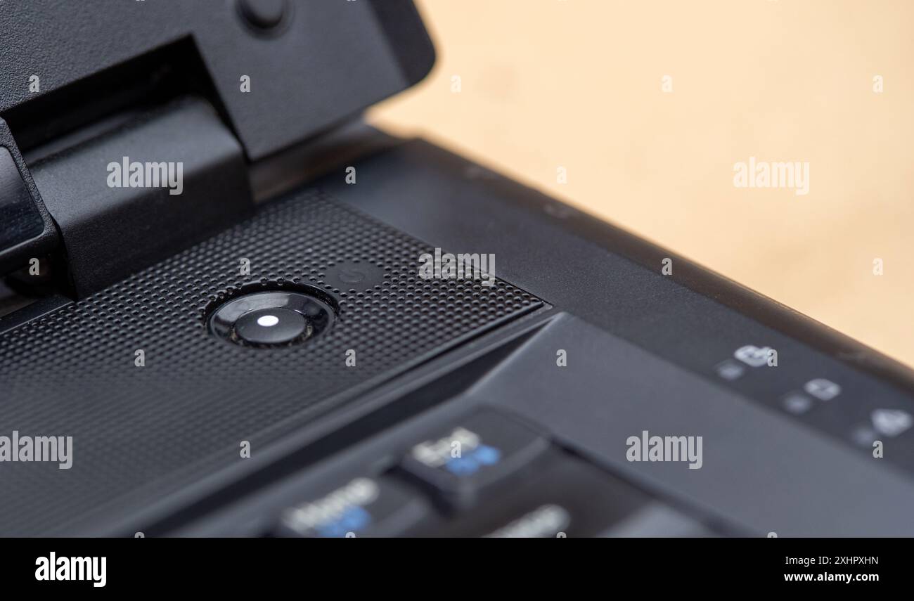 Simple generic round laptop on off button focus, shallow DOF, nobody ...