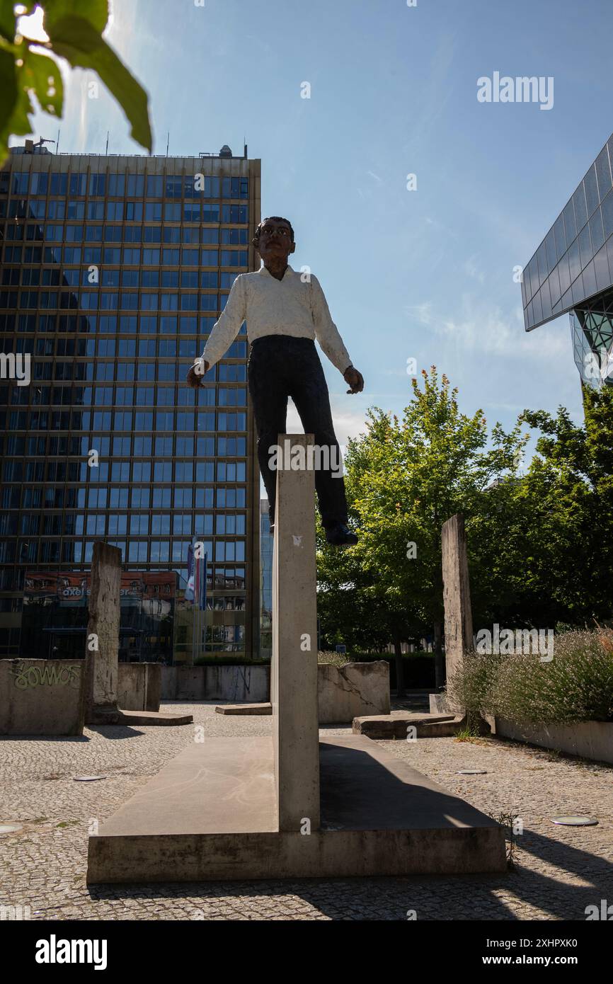 The “Balanceakt” (balancing act) contemporary outdoor sculpture, 3.5m tall painted bronze figure ...