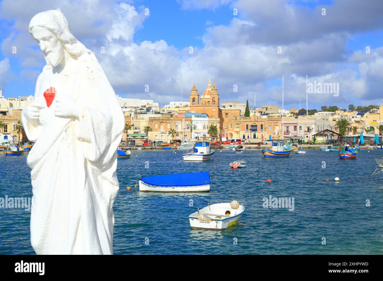 Malta, Marsaxlokk, statue of Jesus Christ with the fishing port and in ...
