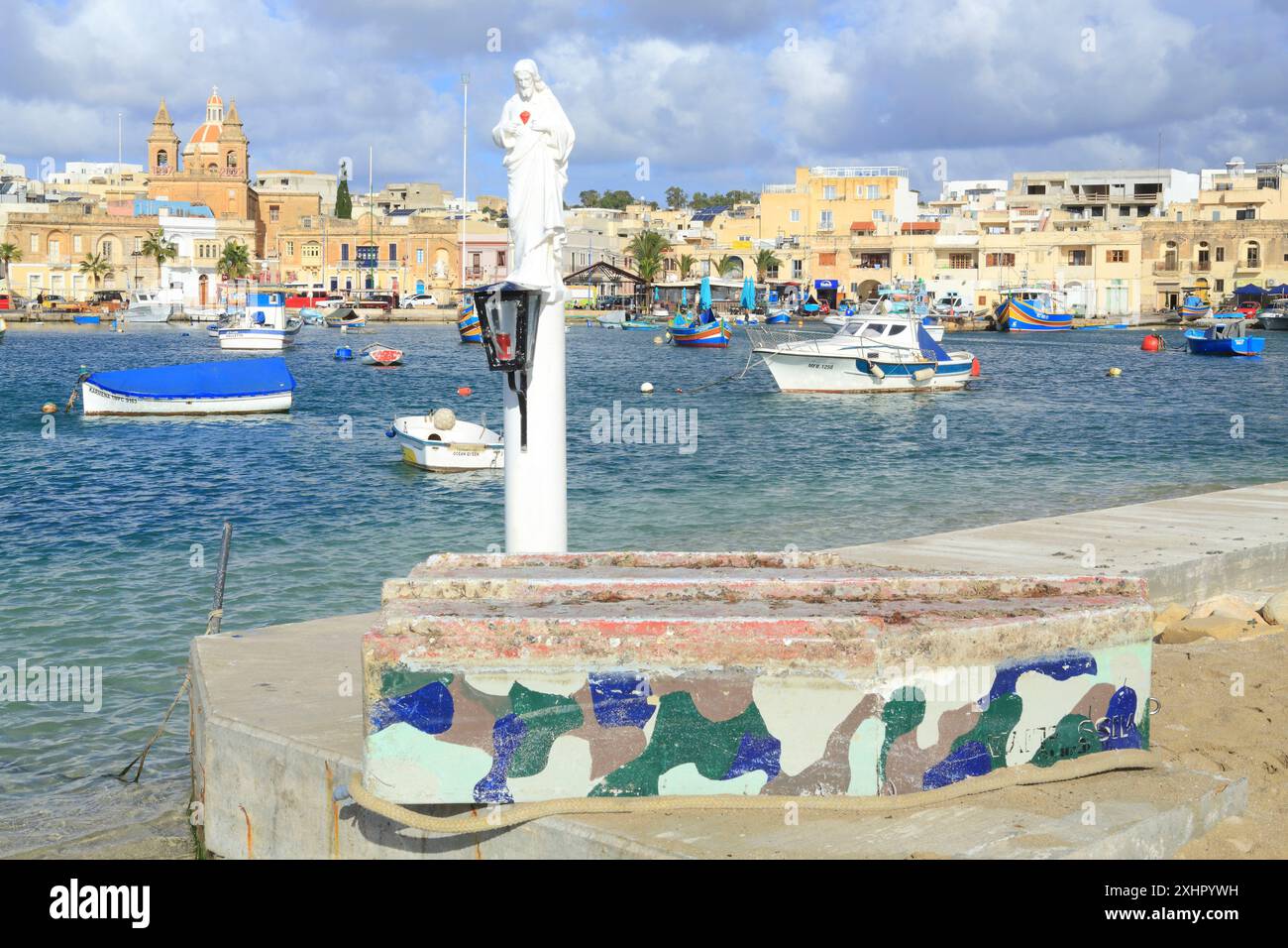Malta, Marsaxlokk, statue of Jesus Christ with the fishing port and in ...