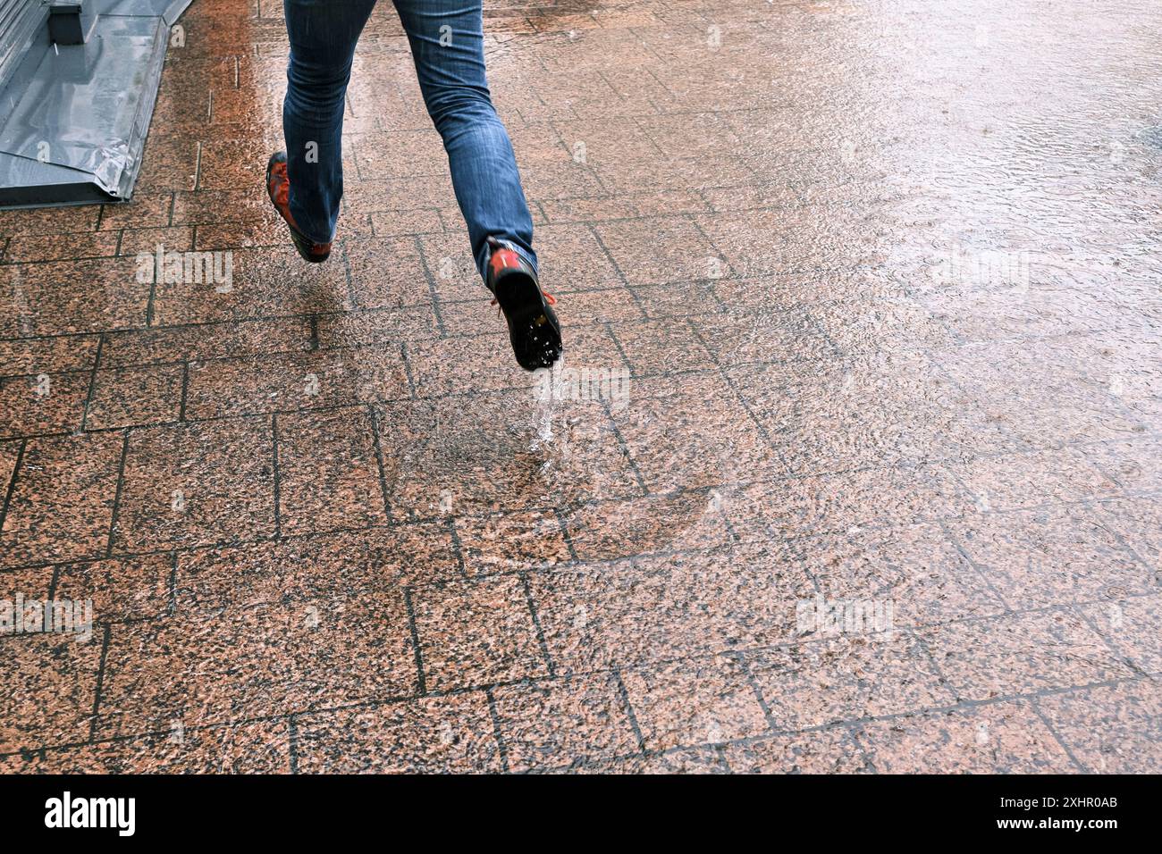 Man jumps over puddle hi-res stock photography and images - Alamy