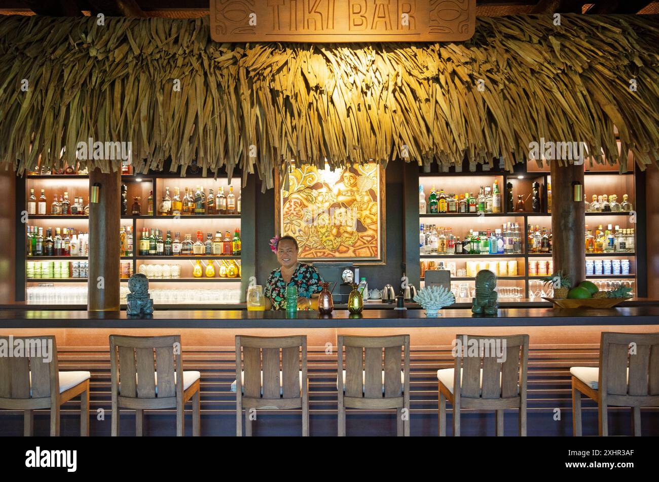 French Polynesia, Taha'a island, Polynesian employee with a hibiscus ...