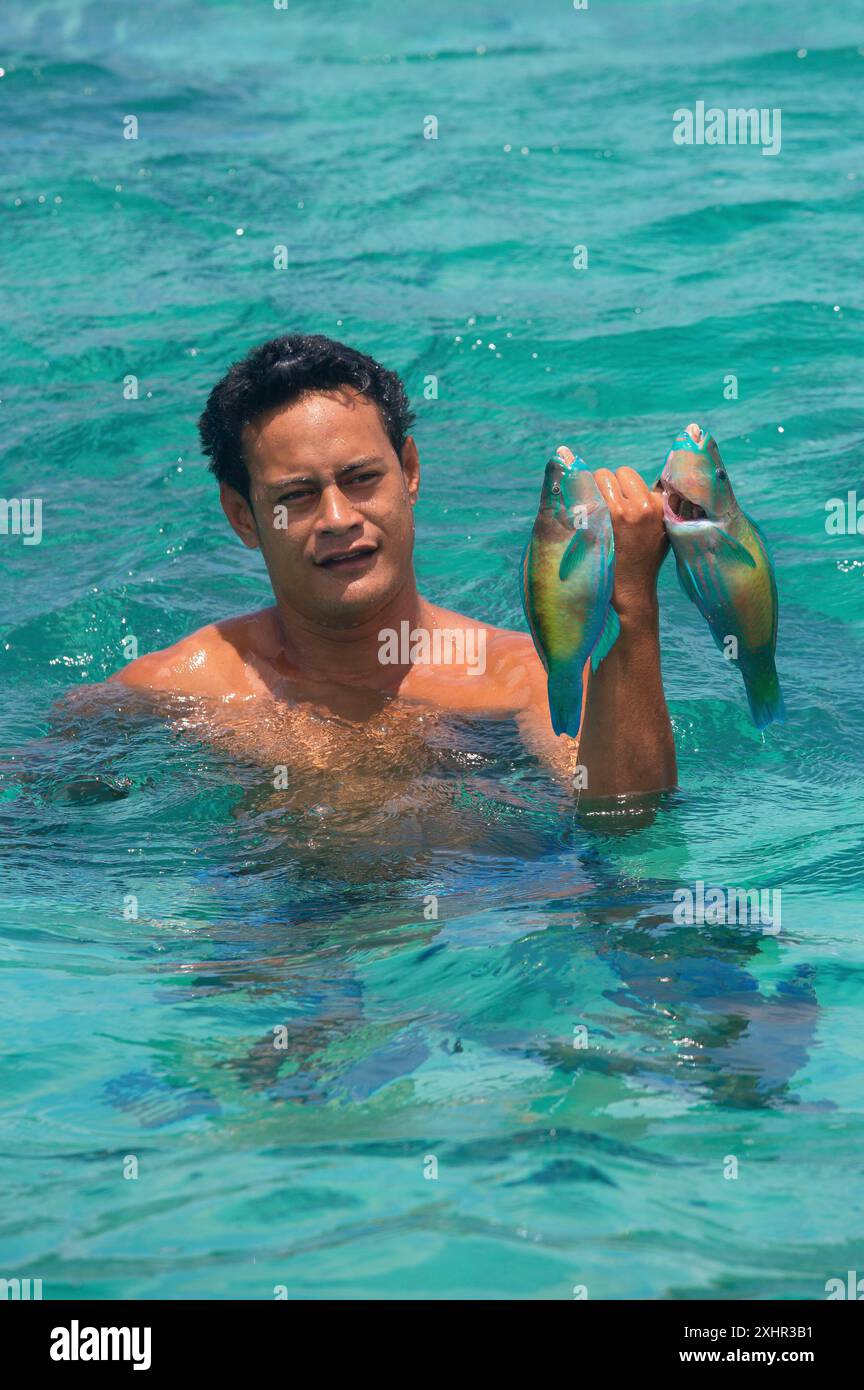 French Polynesia, Bora Bora island, Polynesian fisherman immersed in ...