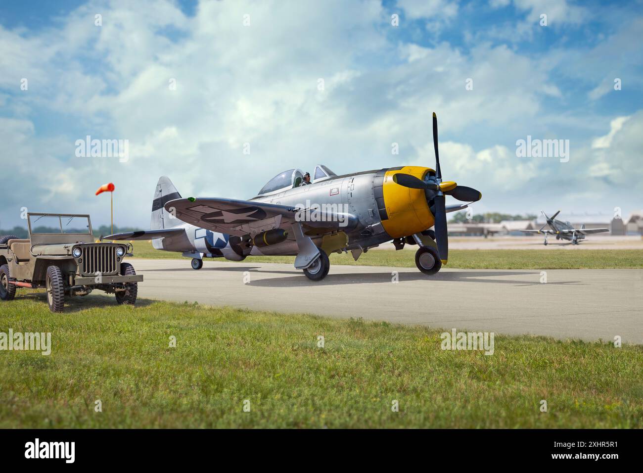 World War II era P-47 fighter plane (model) alongside a jeep sits on a ...