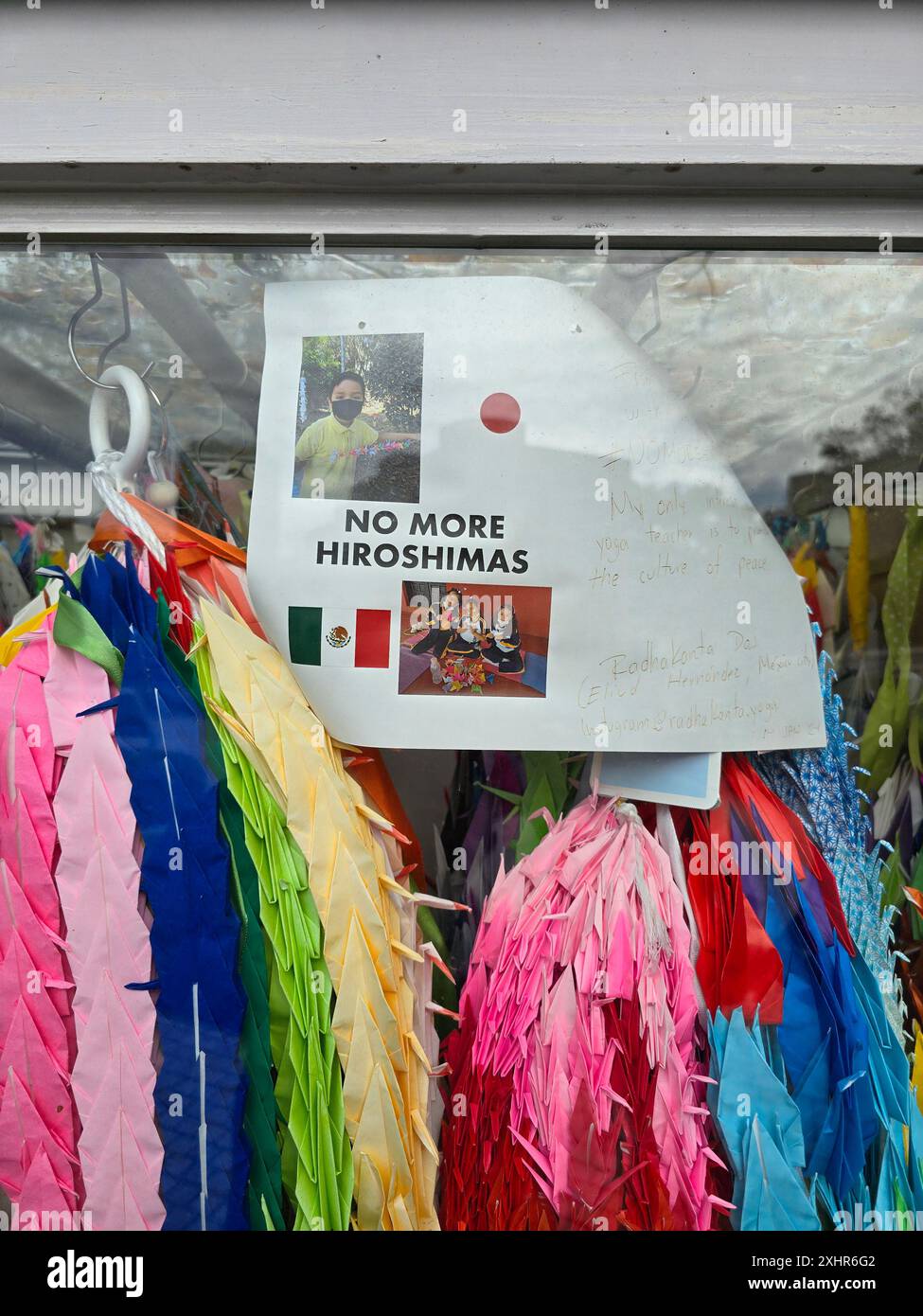 Multicoloured paper ribbons, woven by children and other visitors, are ...