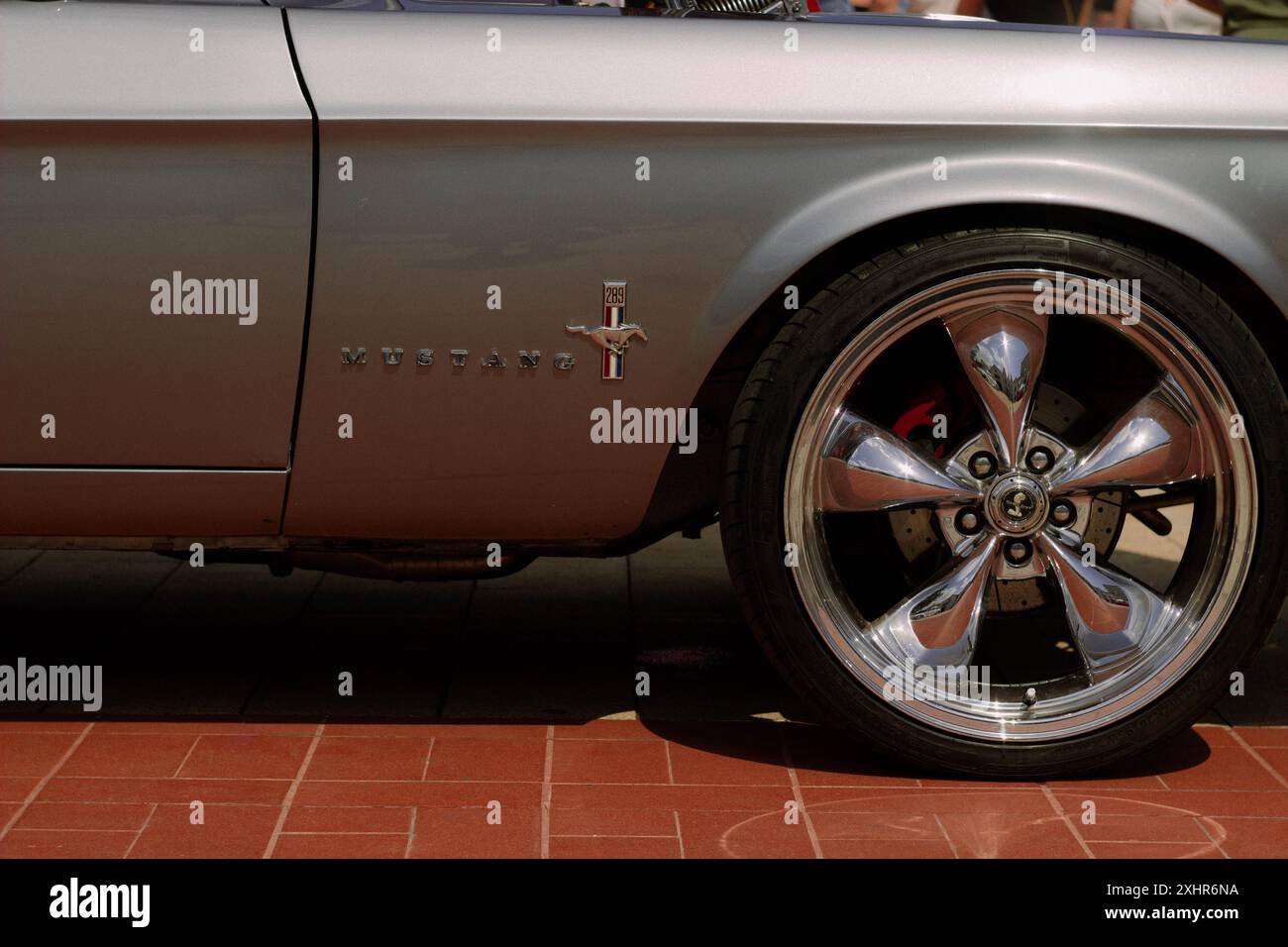 Side view of 1966 Ford Mustang car, showing logo and one wheel Stock ...