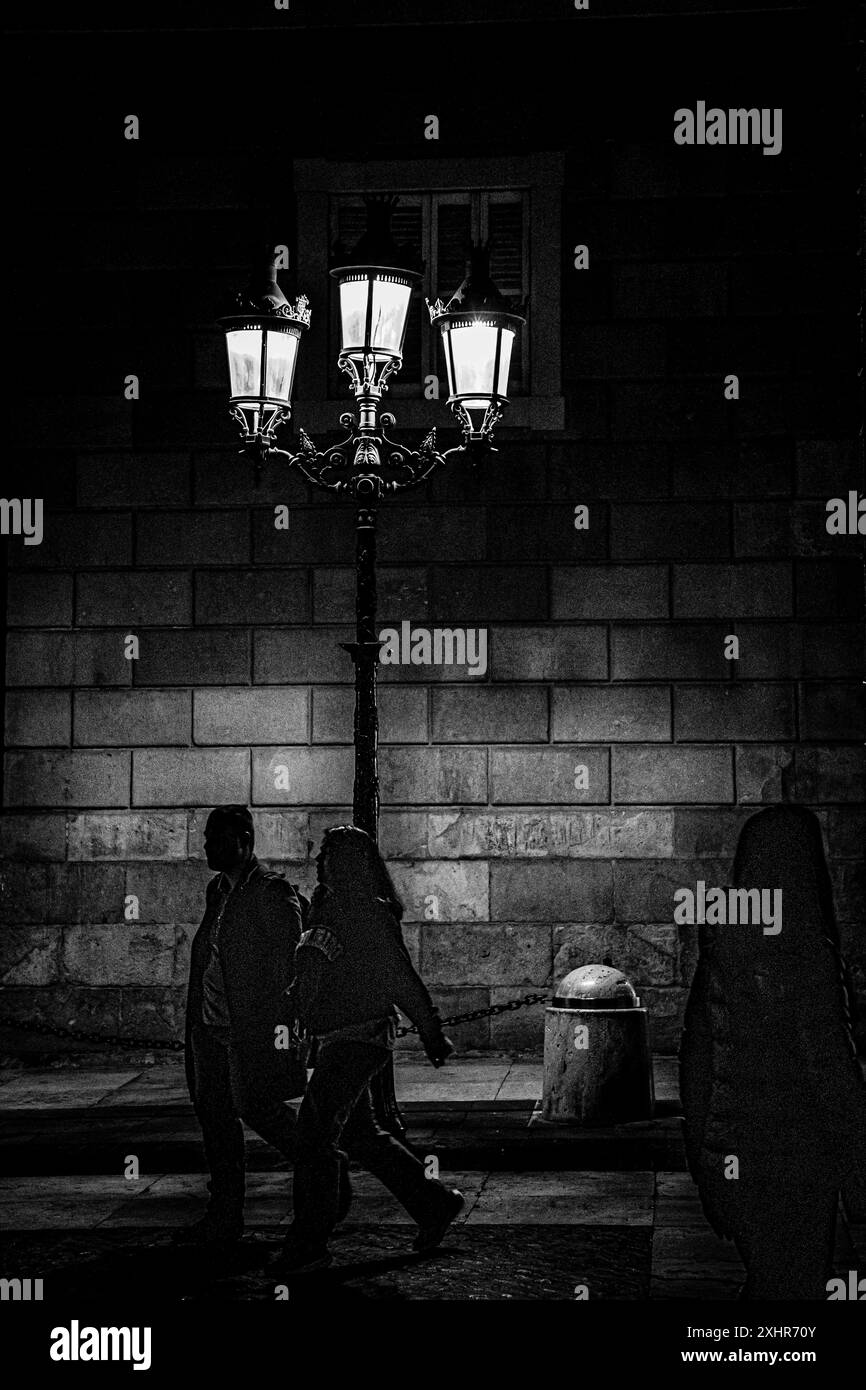 People walking down illuminated Black and White Stock Photos & Images ...