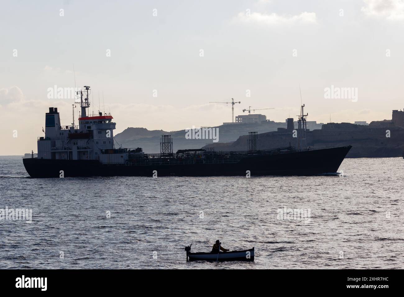 Silhouette of a cargo ship in the Maltese harbor Stock Photo - Alamy