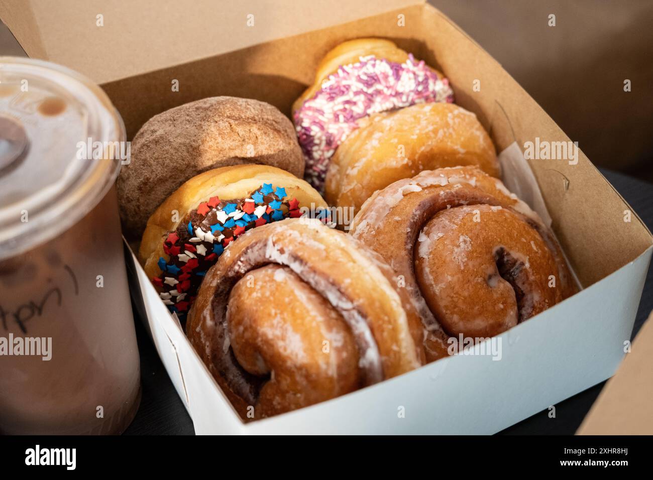 Fancy cake donuts arranged in box with a variety to choose from Stock ...