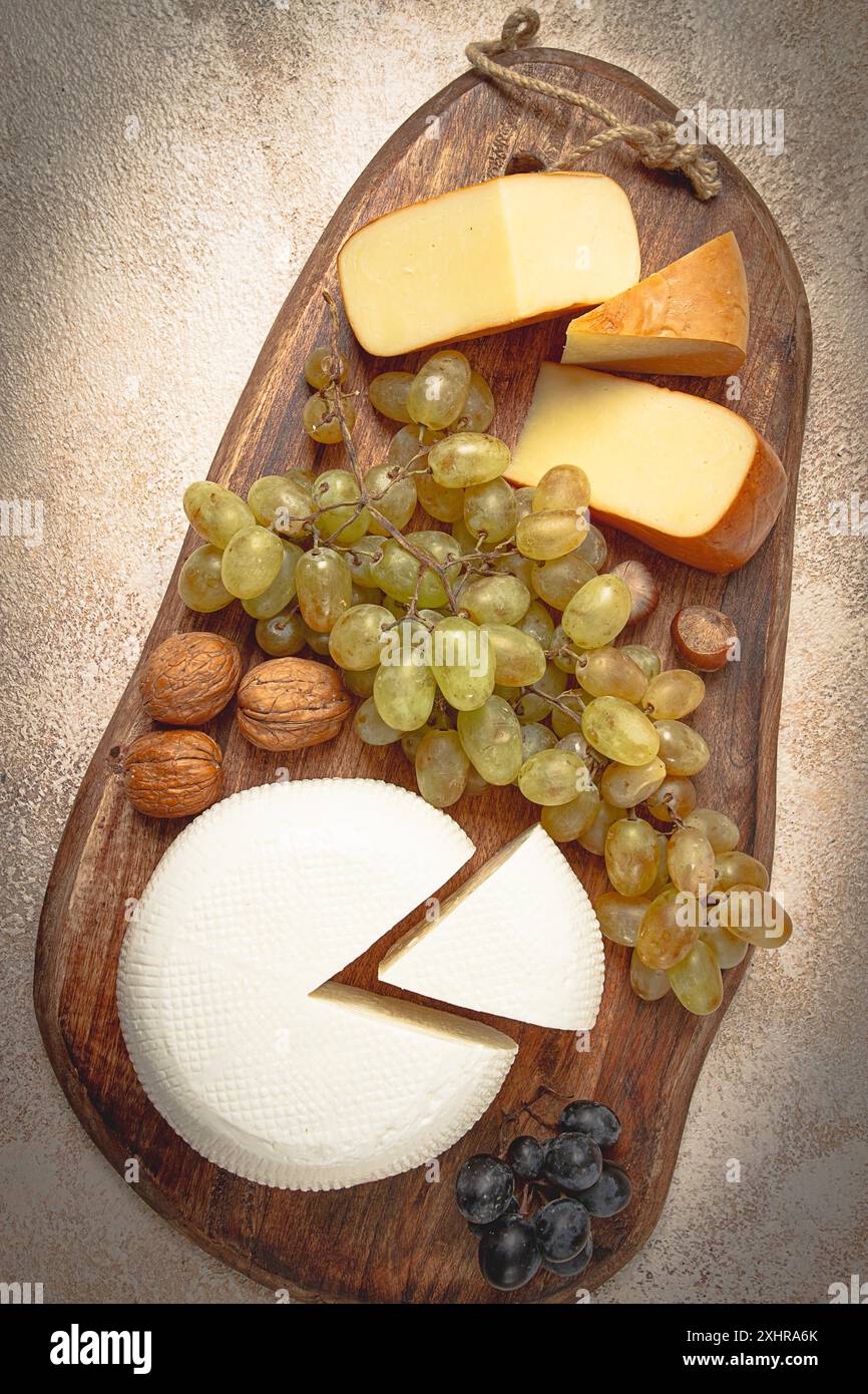 Georgian cheese, Imeretian and smoked suluguni, grapes, nuts, on a ...