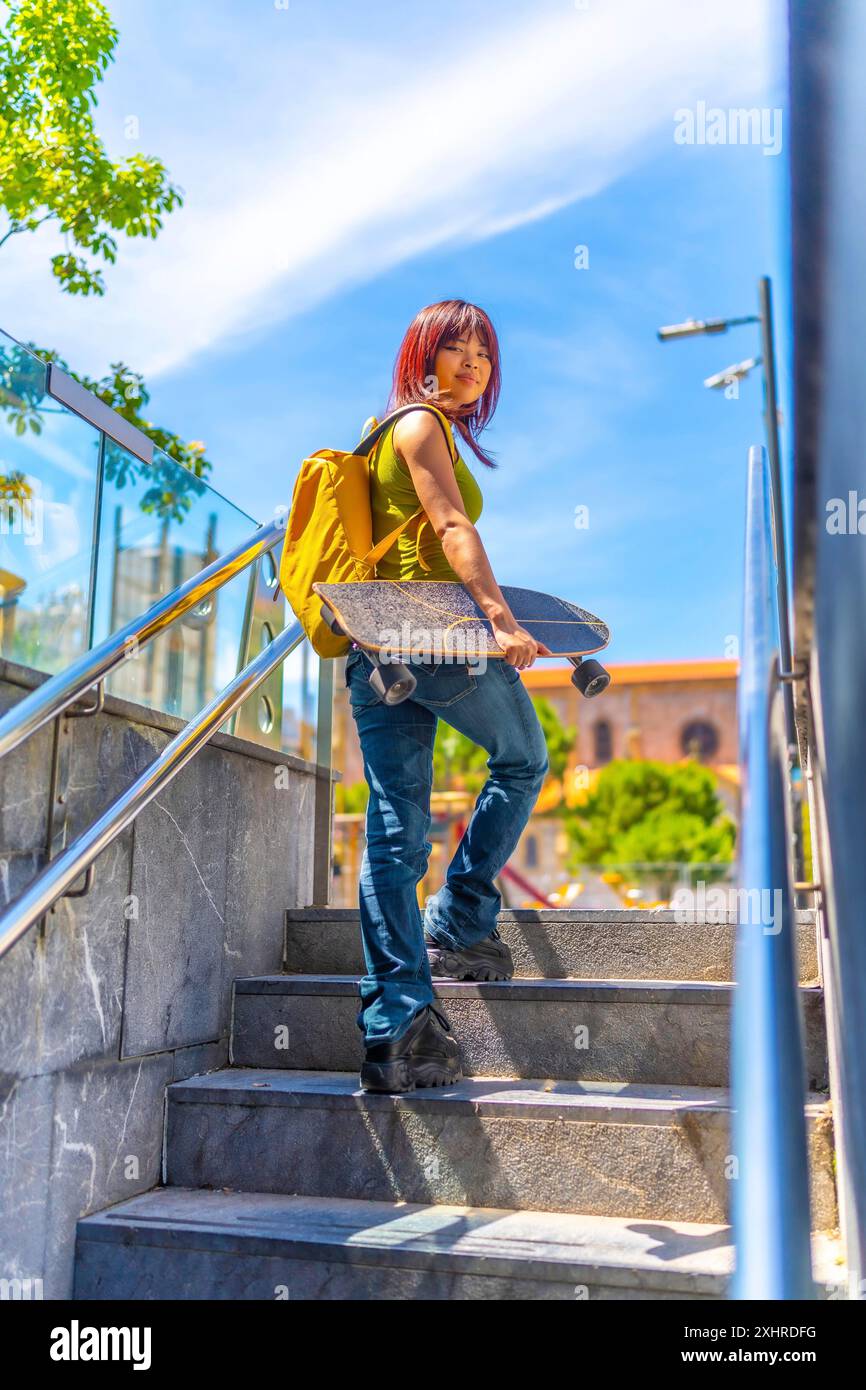 Vertical photo of the rear view of a chinese cool young woman carrying ...
