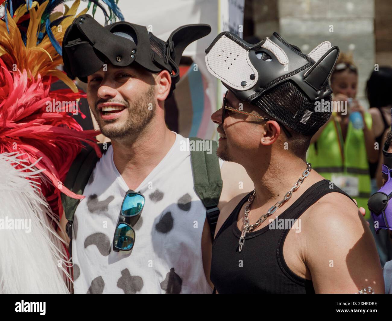 Two men wearing dog masks and sunglasses enjoy the pride event among ...