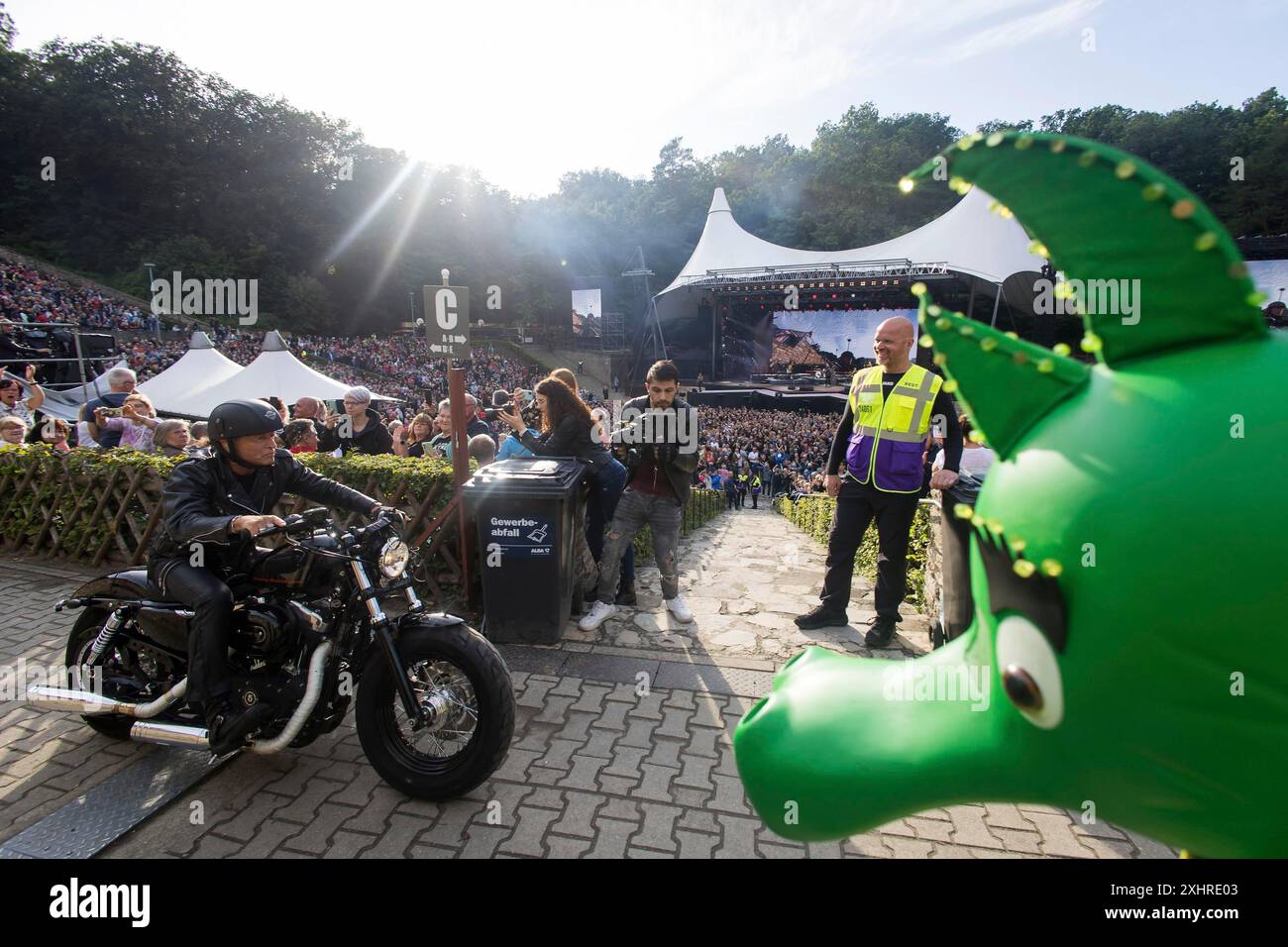 Peter Maffay rides past Tabaluga on his Harley Davidson in front of his ...