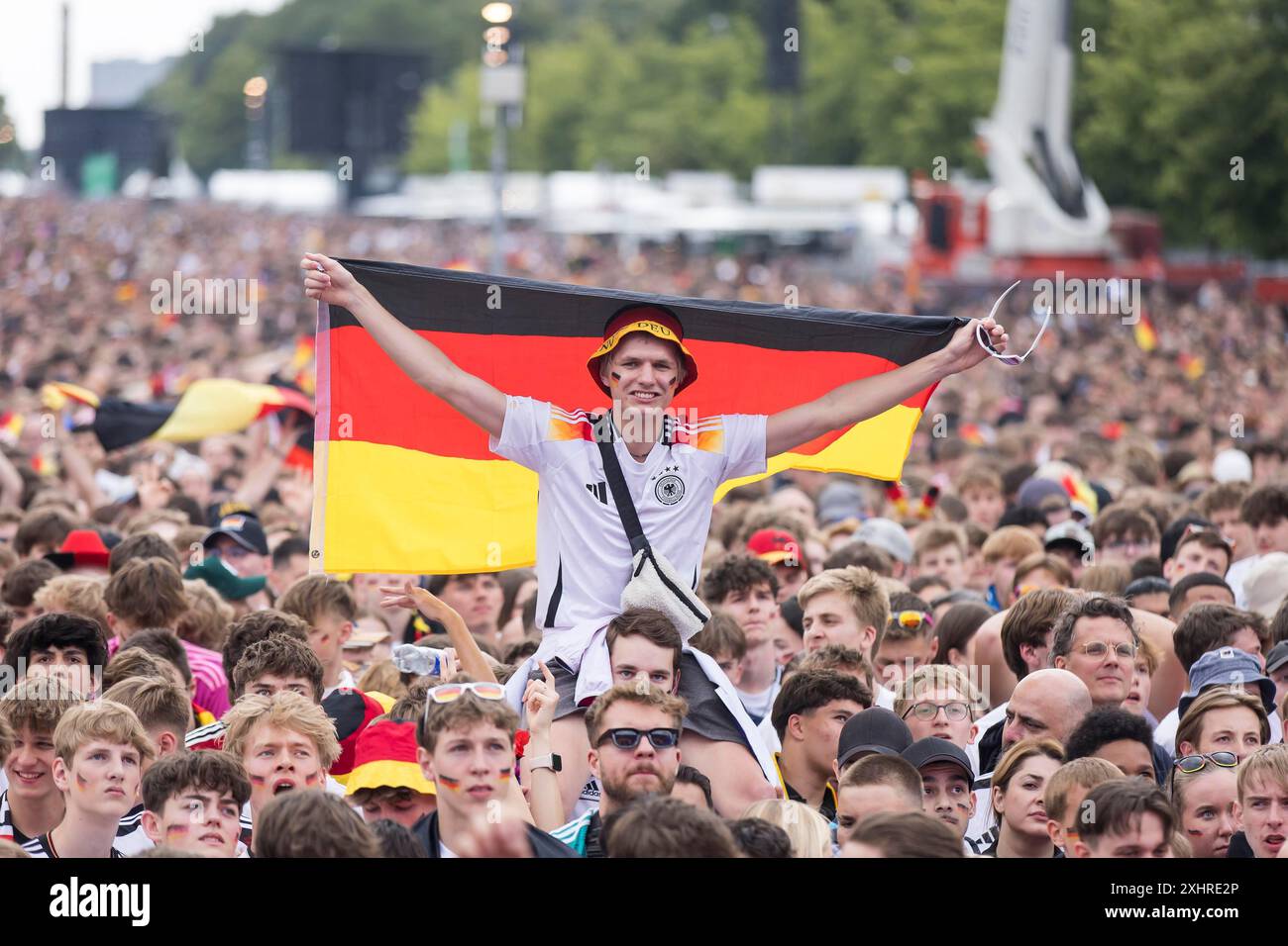 Football fan on shoulders with German flag in the fan zone at the ...