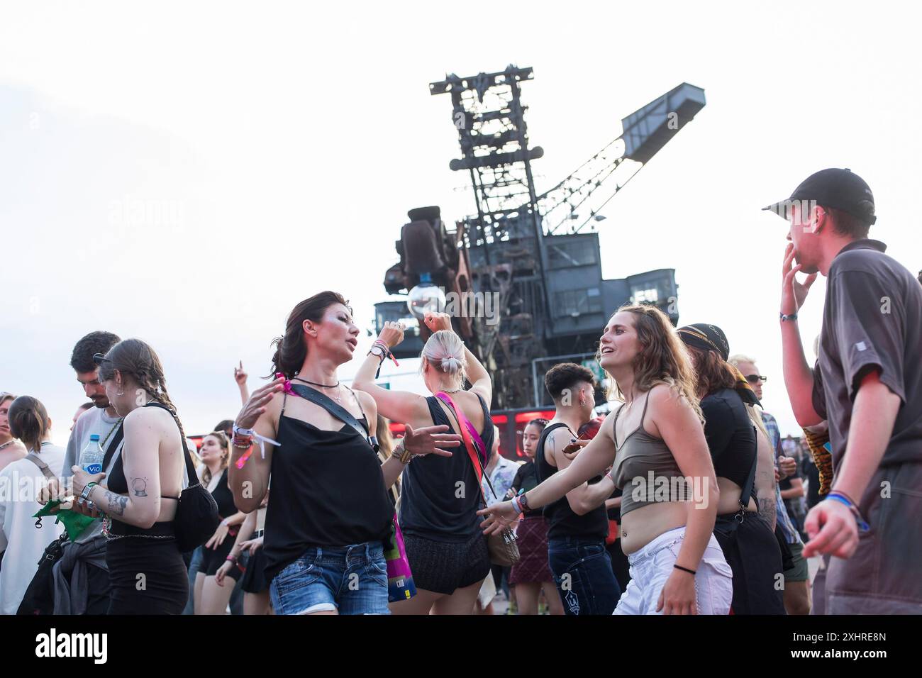 Celebrating visitors in front of excavators at the Melt Festival in ...