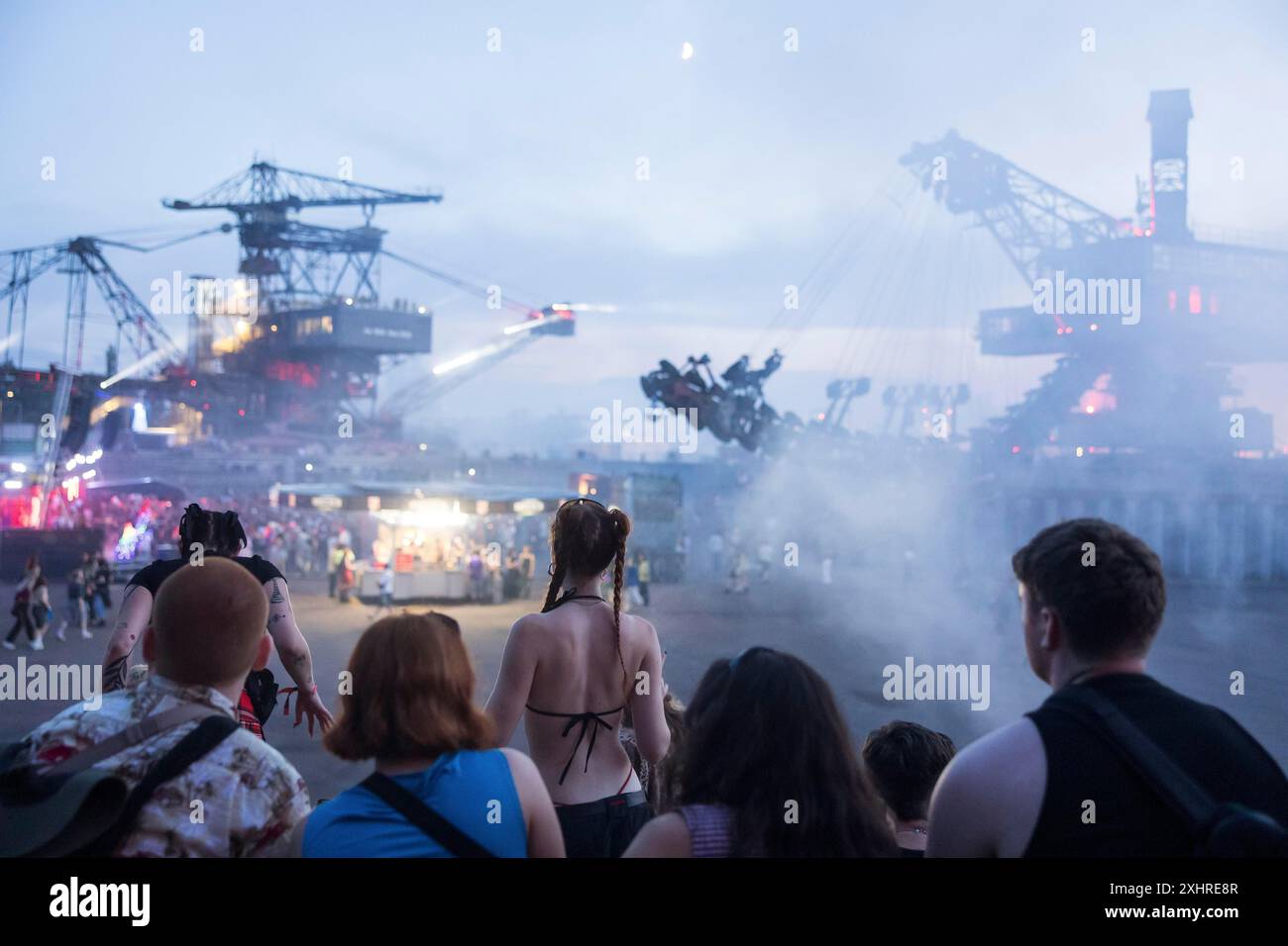 Festival visitors between excavators at the Melt Festival in Ferropolis ...
