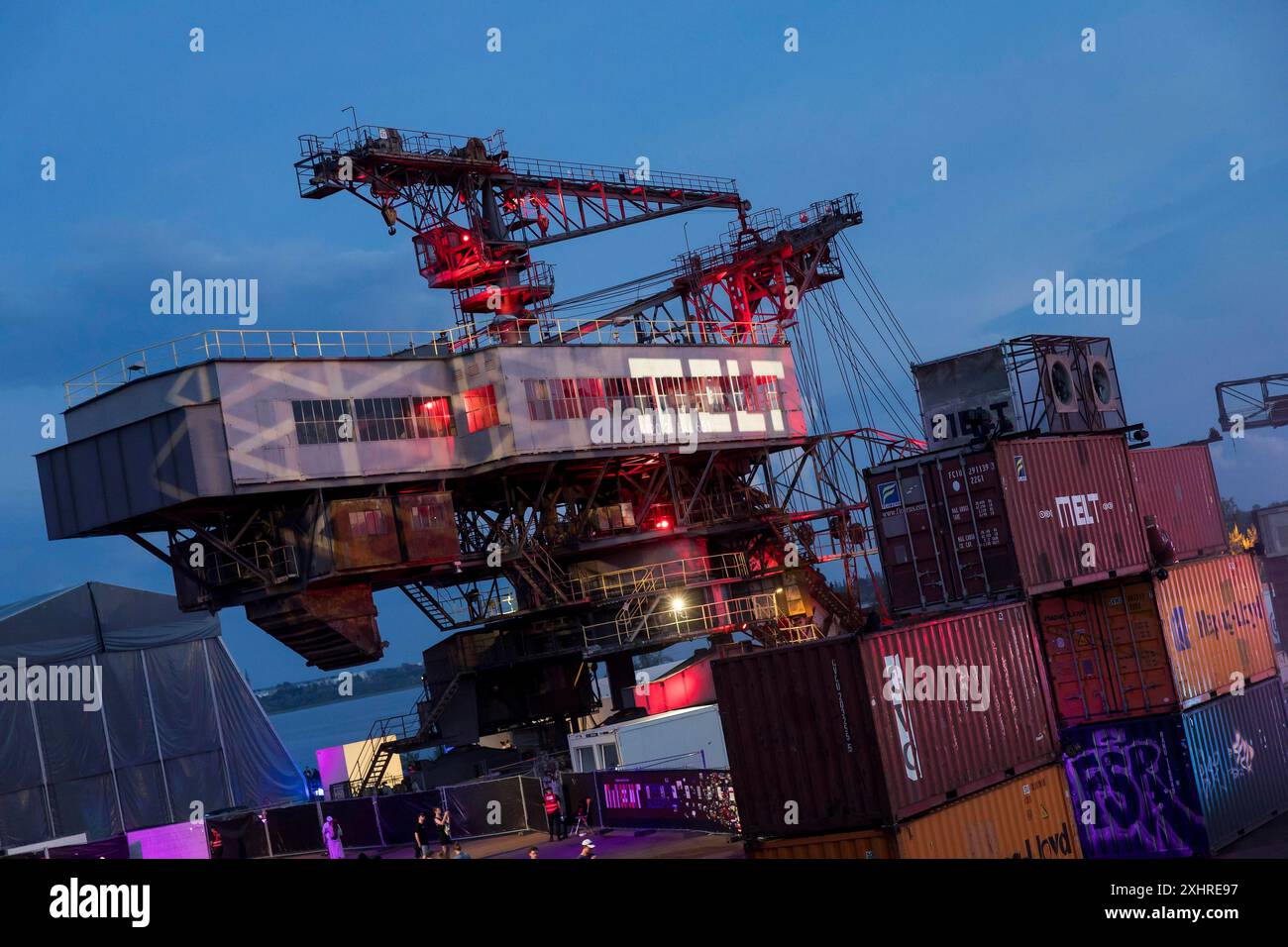 Opencast mining excavators behind containers at the Melt Festival in ...