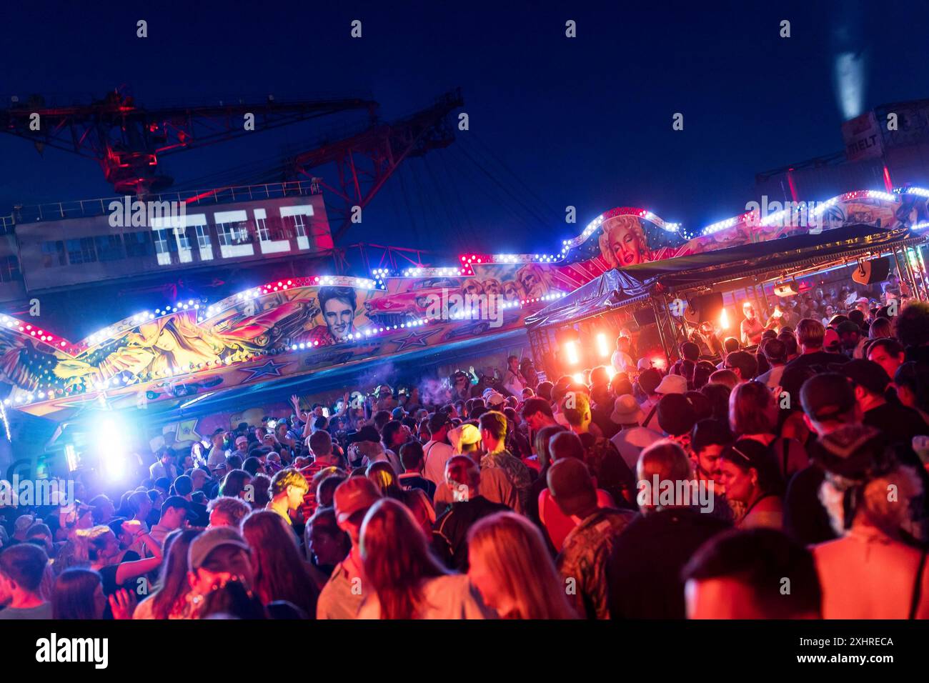 Festival visitors celebrate between bumper cars and excavators at the ...